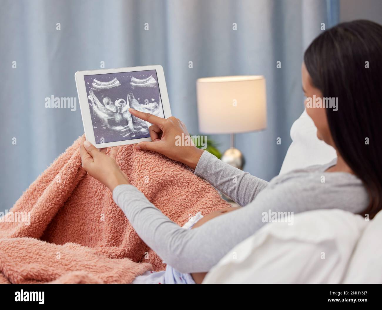 Pregnant, ultrasound scan and mother with tablet in bed with digital x ...