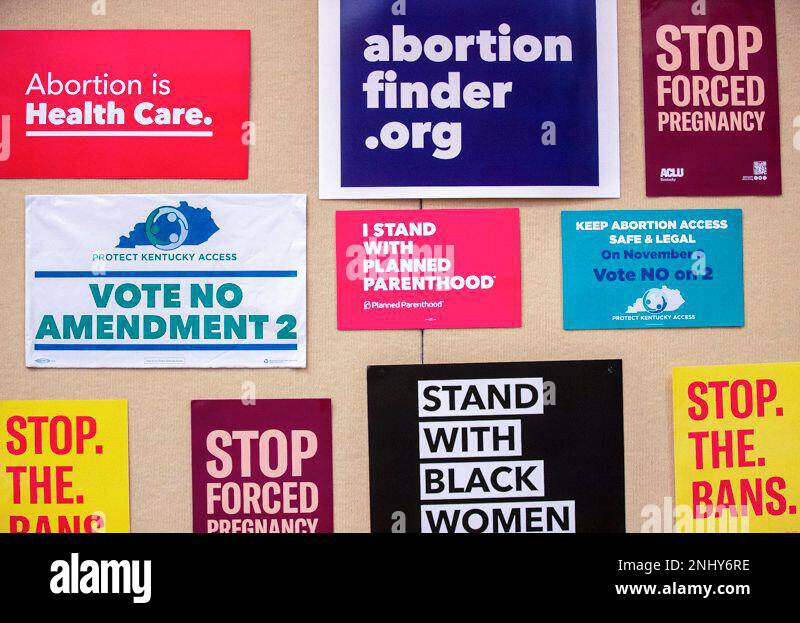 Signs are tacked to the wall at Protect Kentucky Access' election watch ...