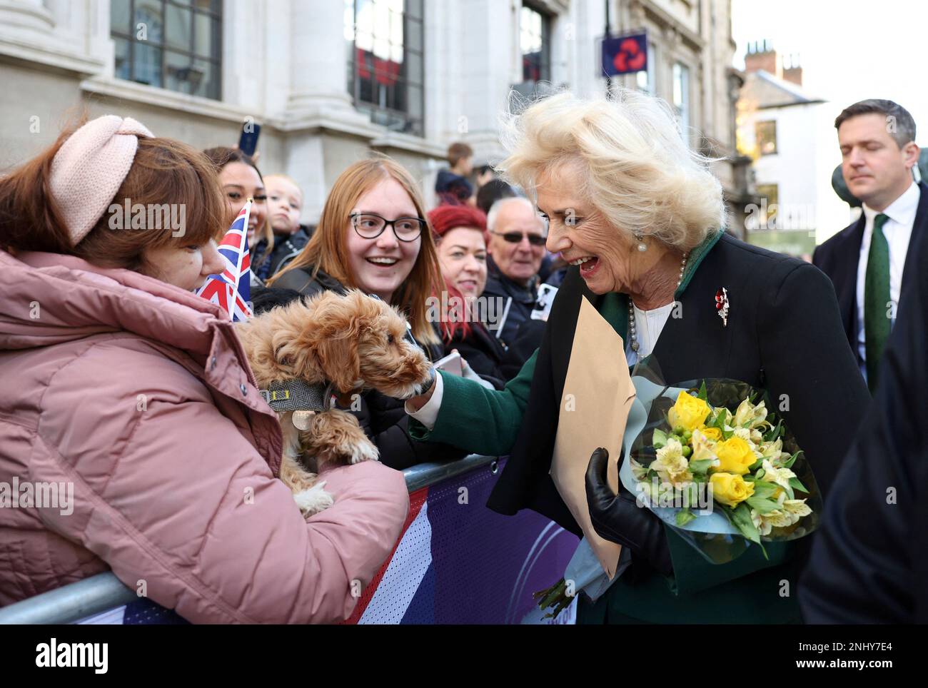 Britain's Camilla, Queen Consort, greets a dog as she visits the ...