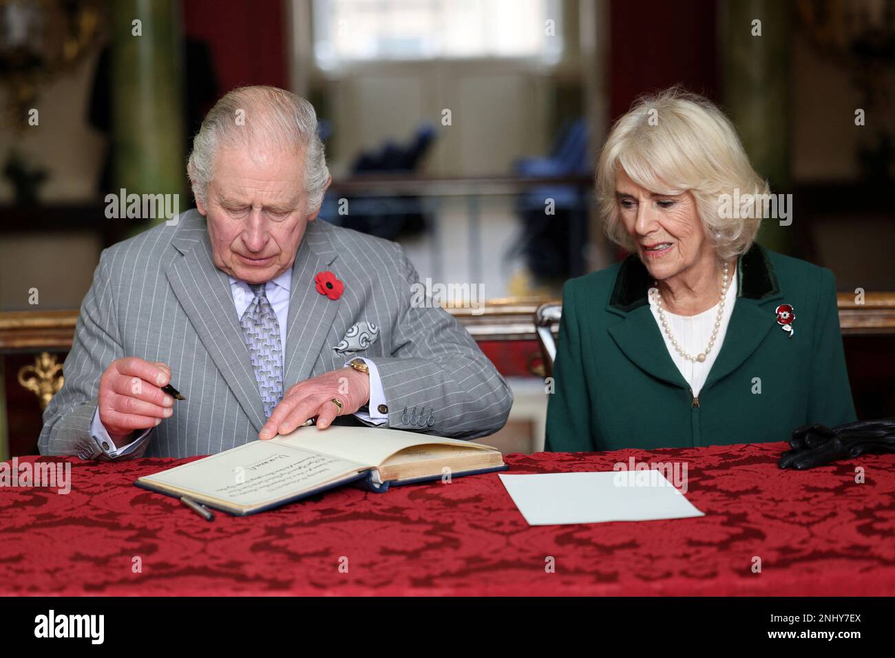 Britain's King Charles III and Britain's Camilla, Queen Consort, sign ...