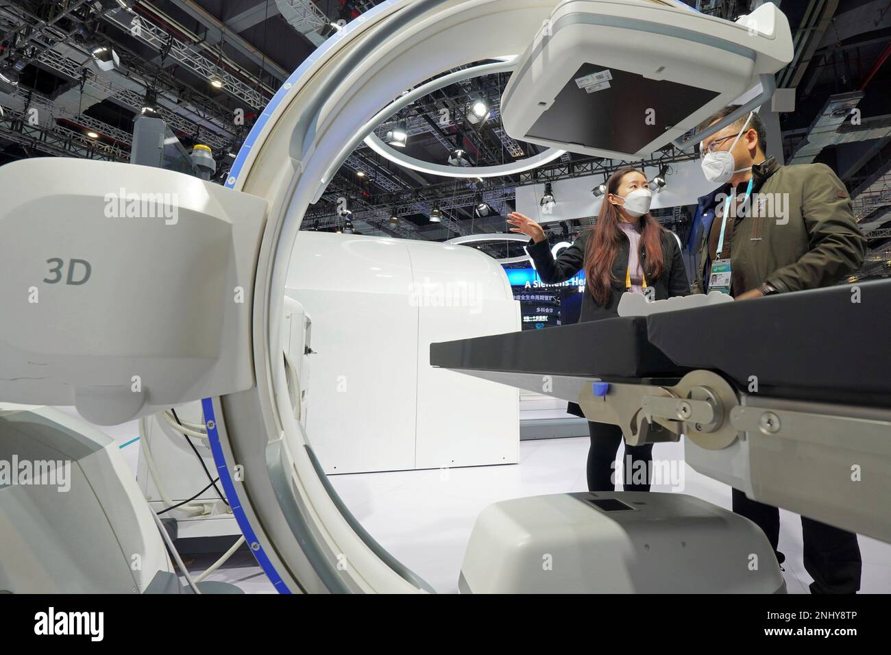 Visitors learn about the latest CT machine developed by Siemens at the ...