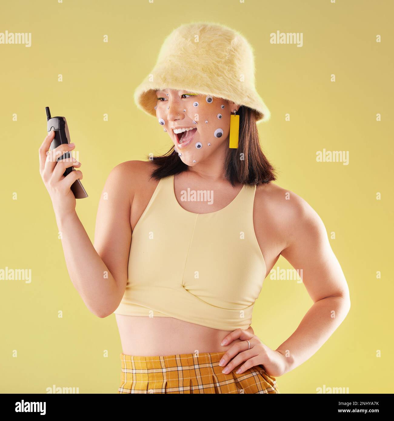 Asian woman, cellphone and studio for surprise, fashion or eyes sticker ...