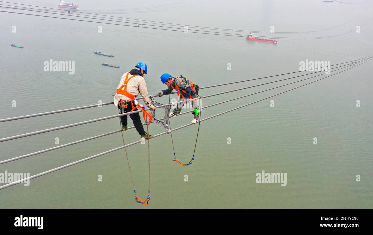 Aerial photo shows workers checking the wires of the world's highest transmission tower in Wuxi ...