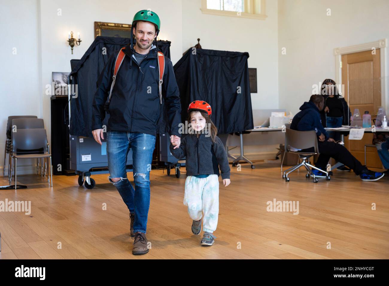 Michael Pechter and his daughter Naomi Pechter, 3, emerge from a voting ...