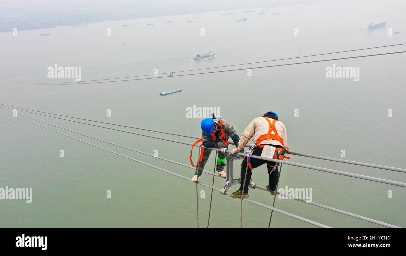 Aerial photo shows workers checking the wires of the world's highest transmission tower in Wuxi ...
