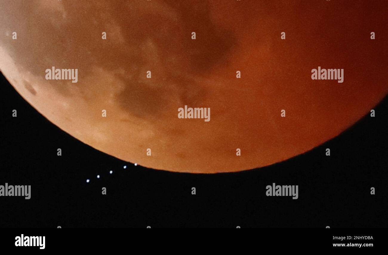 A total lunar eclipse with Uranus is seen in Chiyoda Ward, Tokyo on Nov ...