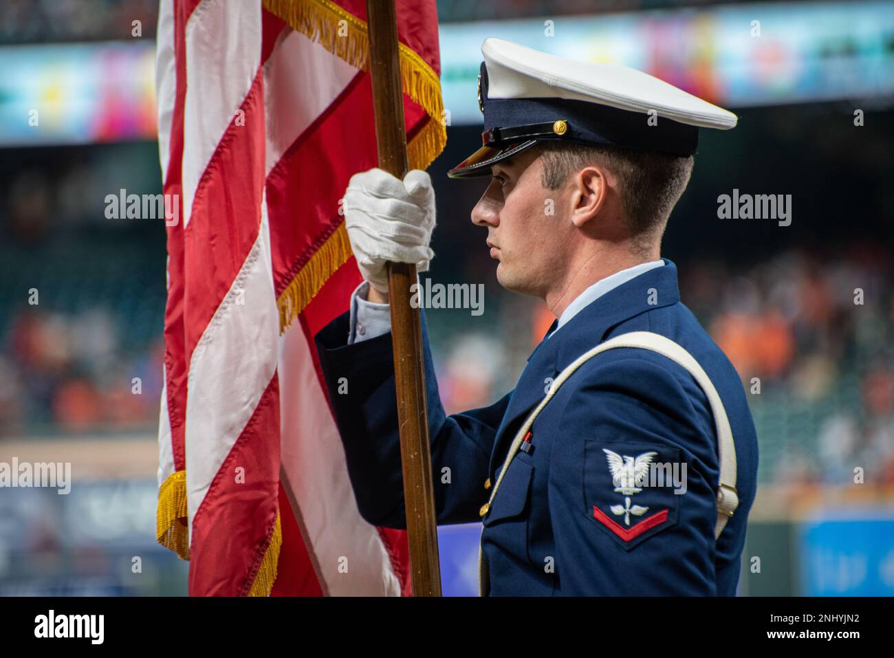 A member from Coast Guard Air Station Houston presents the colors ...