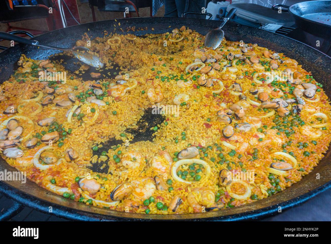 Close up view of a pan of seafood paella with prawns, muscles, squid ...
