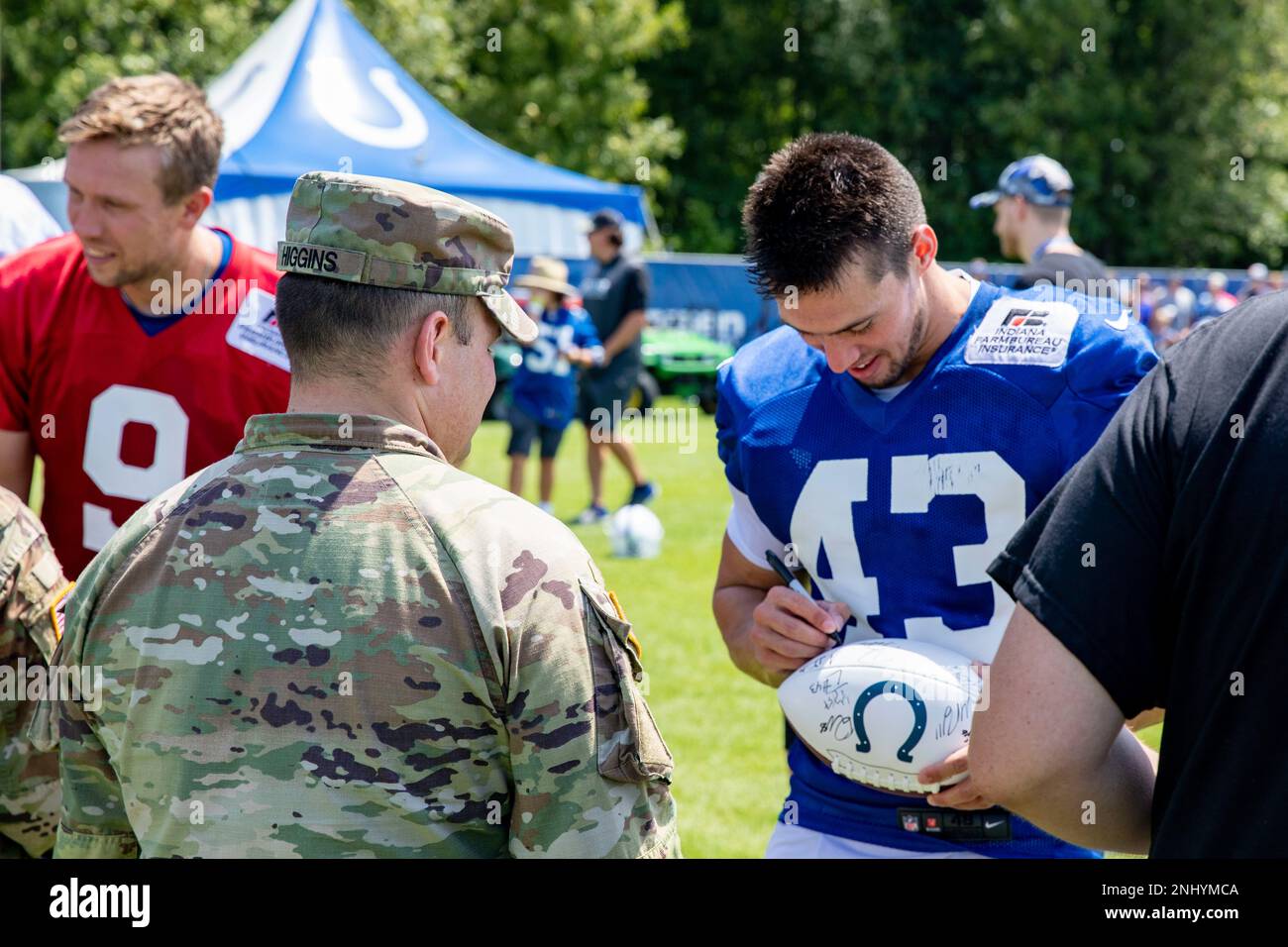 Military service members interact with Colts players after the end of ...