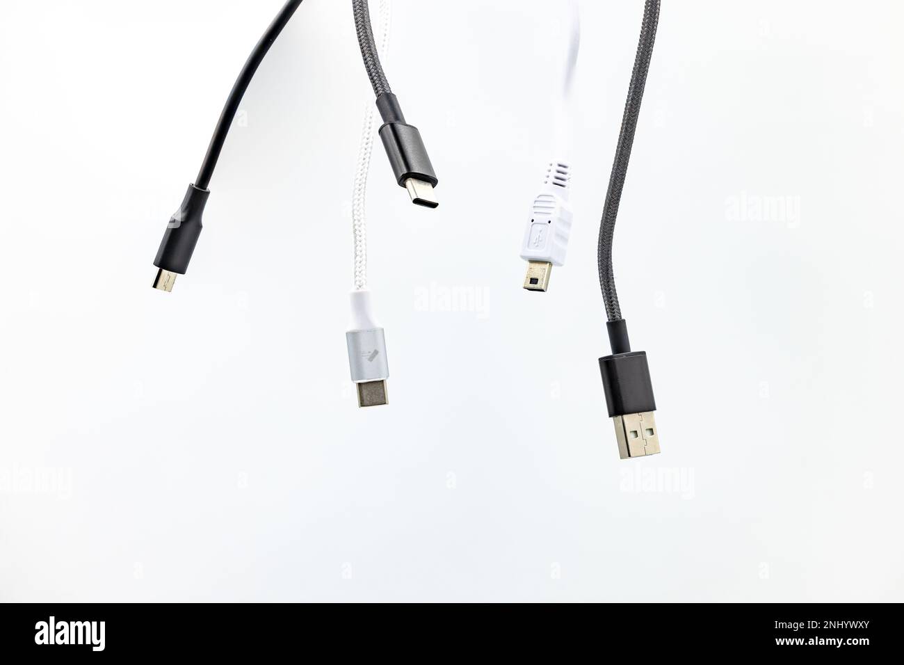 Jumble with many cables, USB plugs and standards isolated against a ...