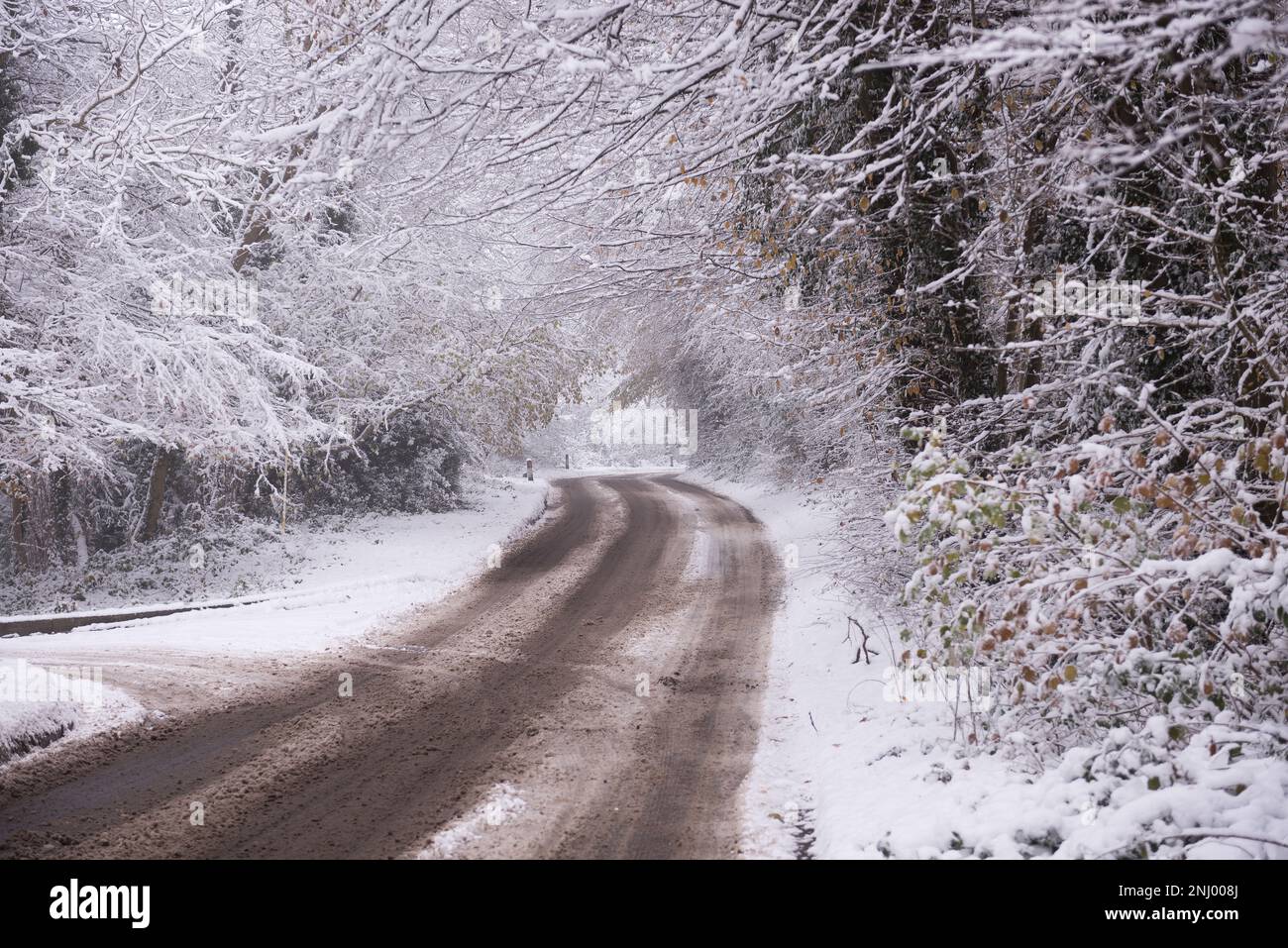 Salt spread on roads helps to melt new snow fall but the freezing slush ...
