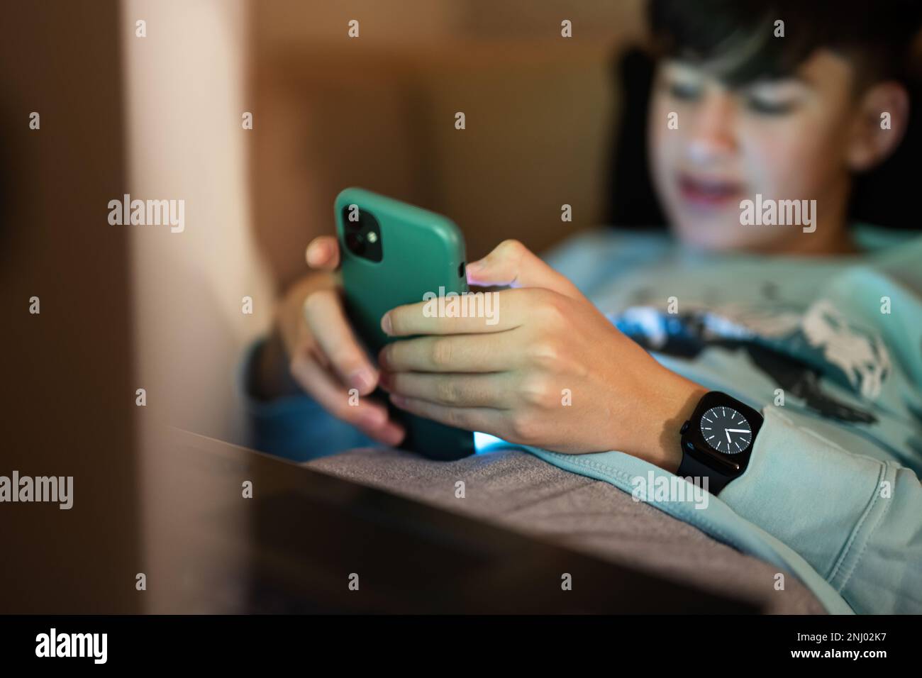 Teenage boy texting in bed hi-res stock photography and images - Alamy