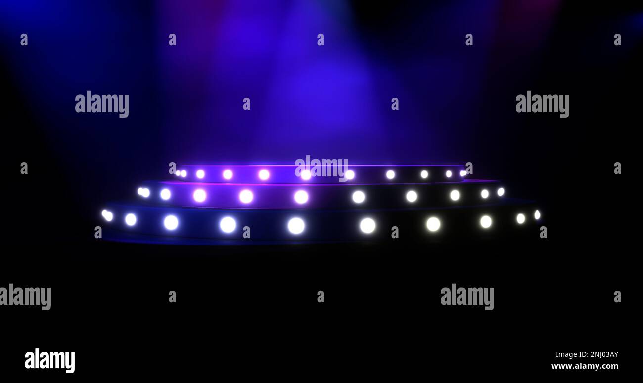 Circular stage set with steps illuminated by blue and purple spotlights ...