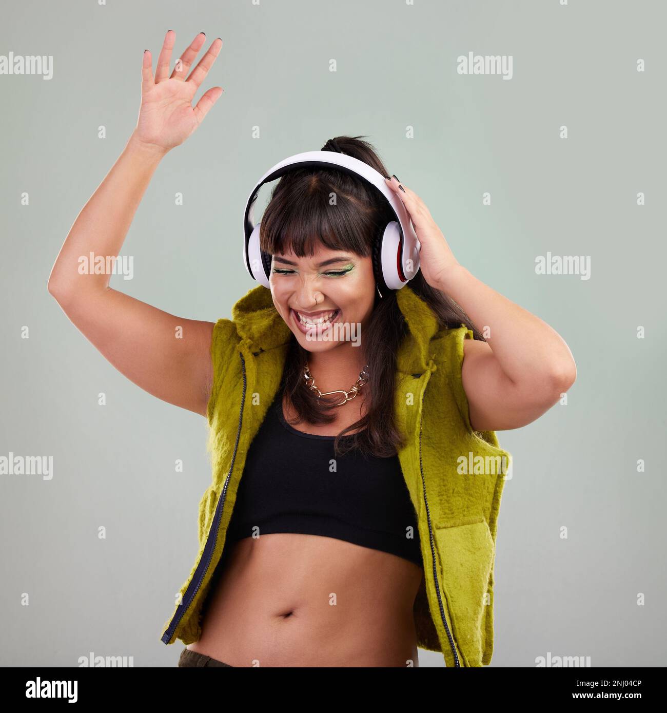 Punk, dance and woman with headphones, celebration and music streaming ...