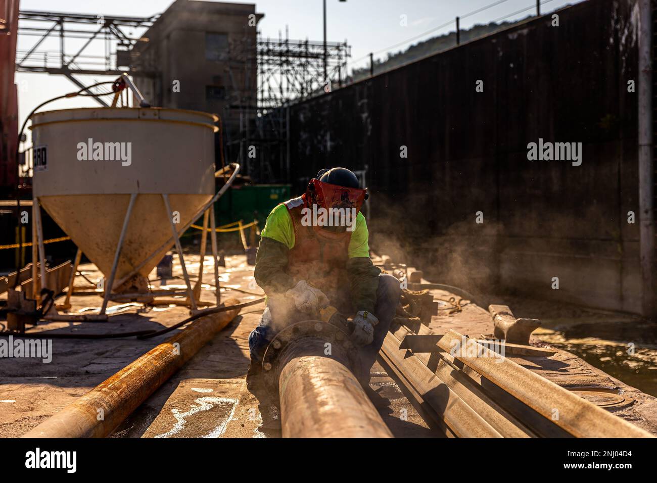 Construction workers from a contracting firm drill holes into the ...