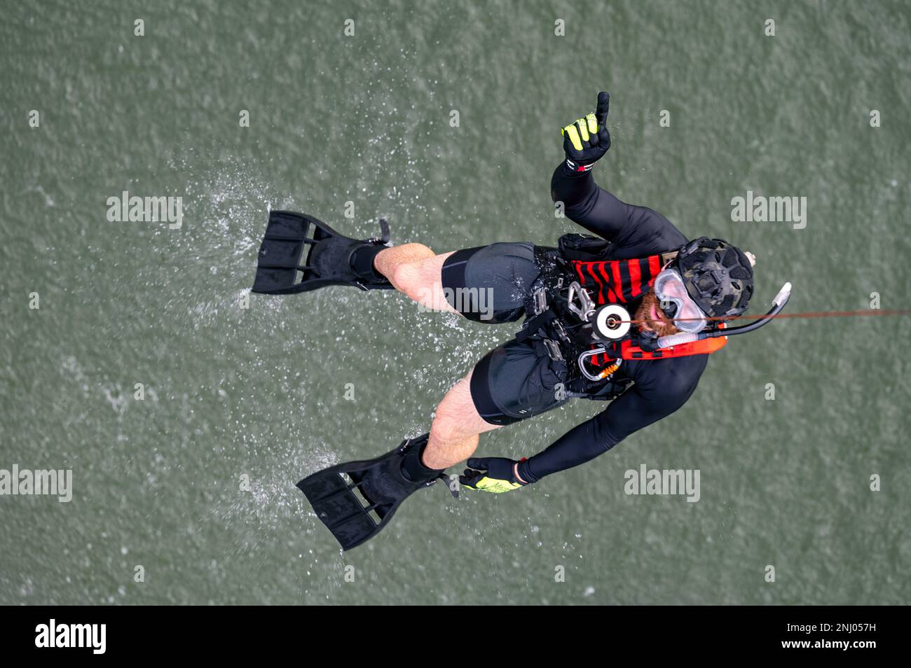 An FBI Hostage Rescue Team member is raised to a H-60M Black Hawk ...