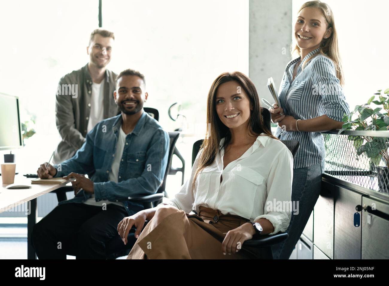 Happy businesspeople laughing while collaborating on a new project in an office Stock Photo - Alamy
