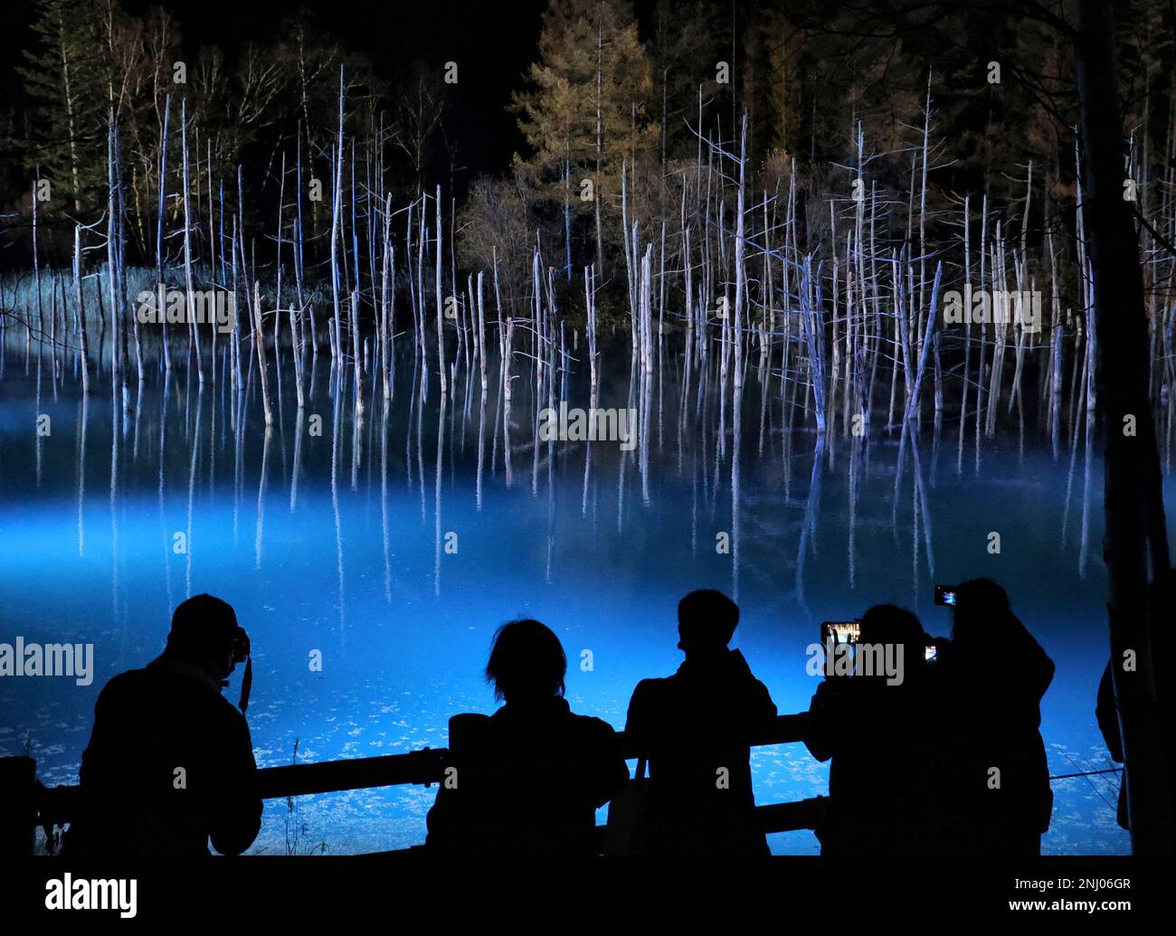The Blue Pond, a popular tourist spot, is lit up with lights, giving ...