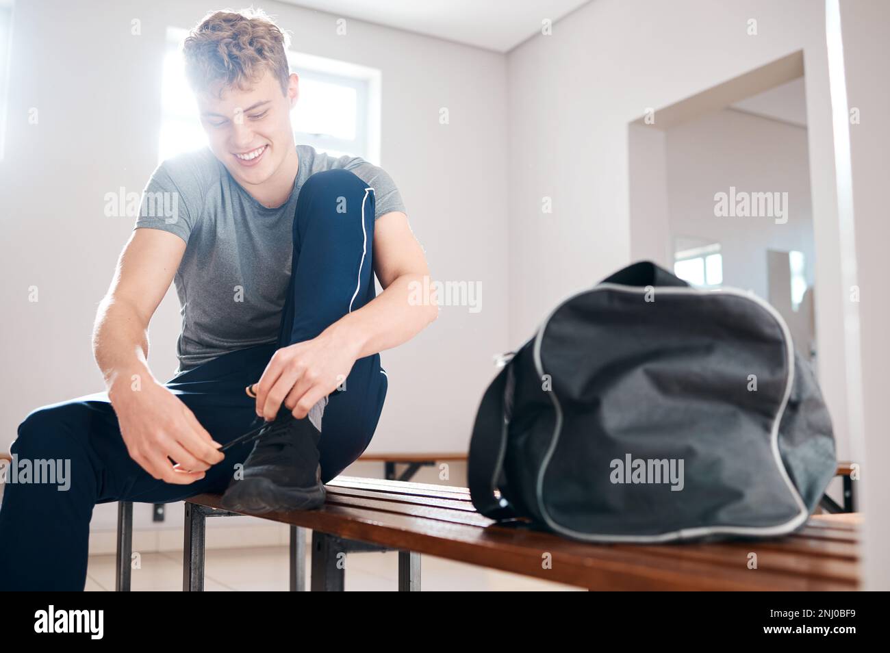 Fitness, tying shoes and man in locker room for training, sports and ...