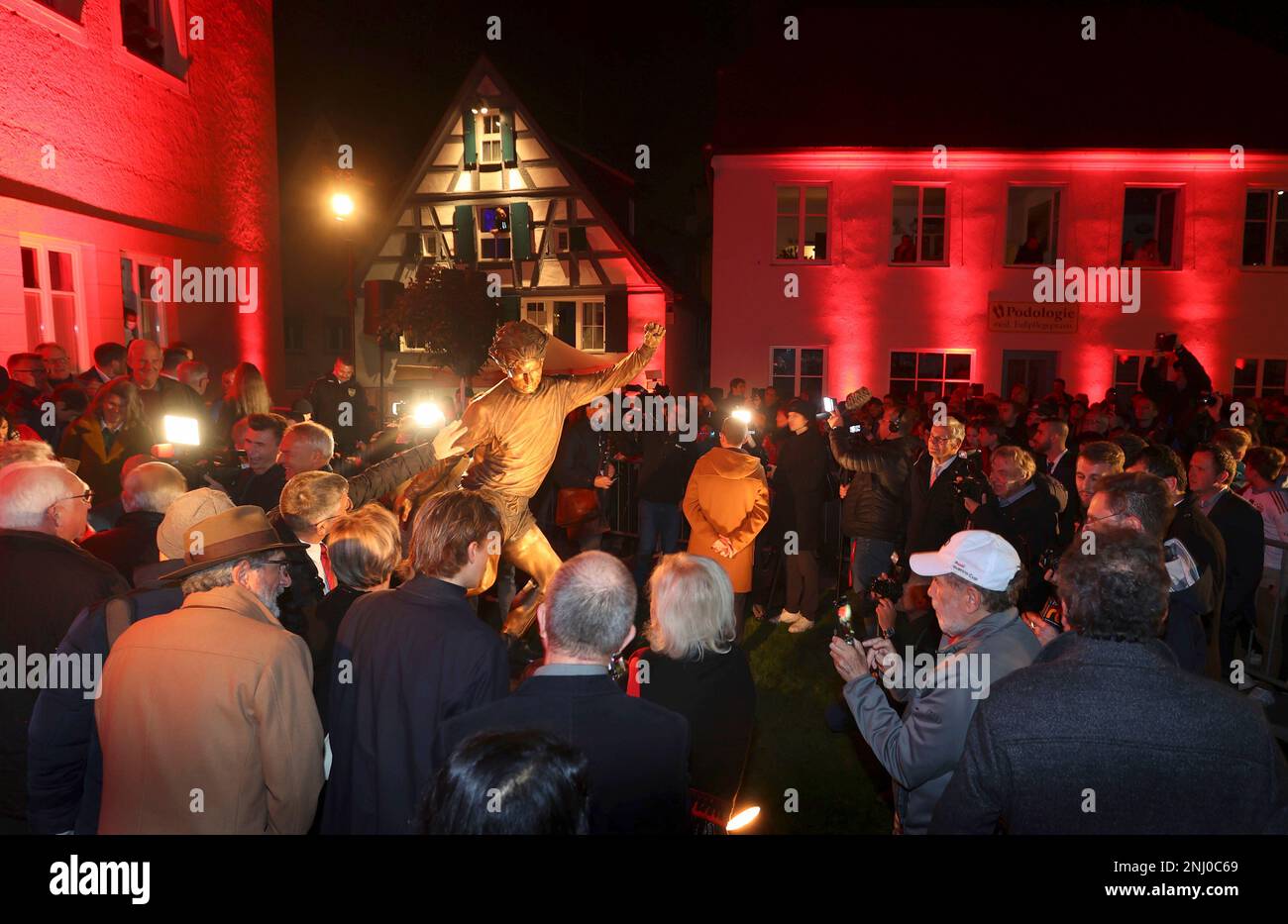 People surround a statue of Germany soccer player Gerd Muller, after ...