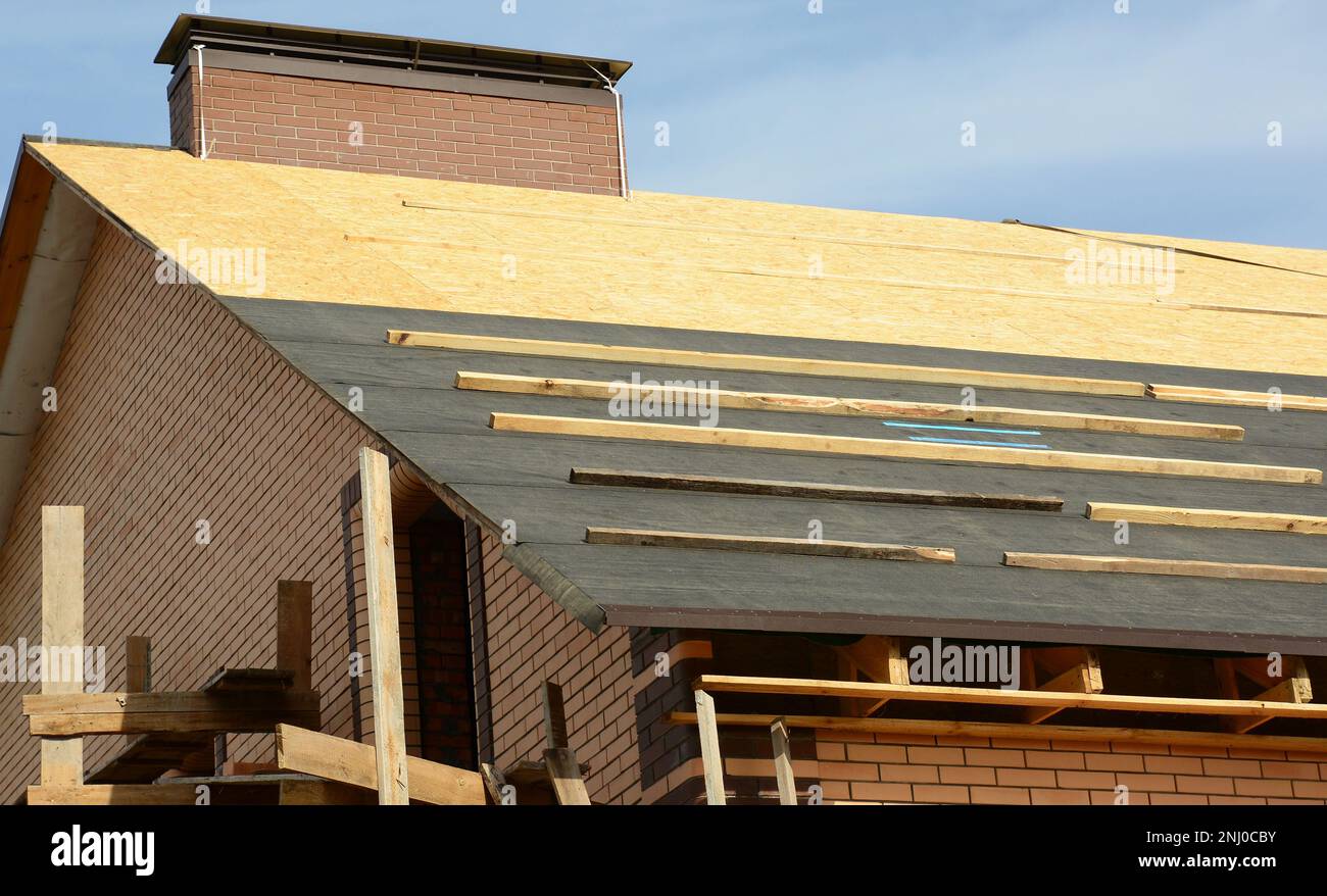 Brick house roofing construction with vapor barrier before laying ...