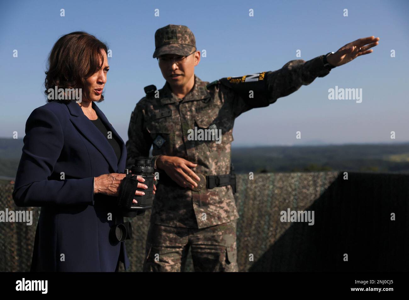 FILE - Vice President Kamala Harris, left, holds binoculars at the ...