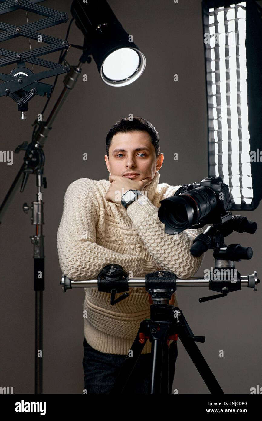 Professional handsome photographer with digital camera on tripod Stock ...