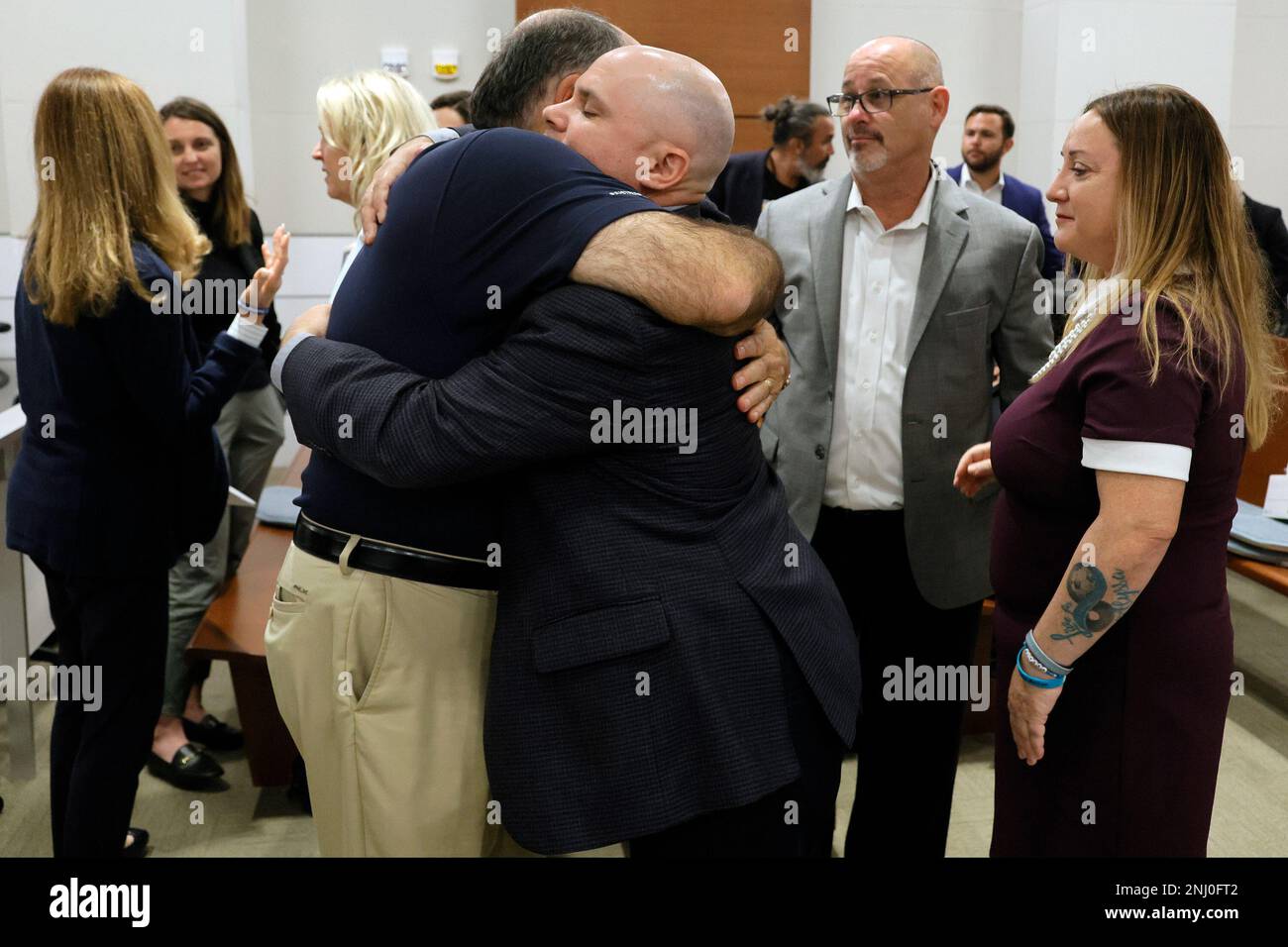 Michael Schulman, left, and Ilan Alhadeff embrace during a break in the ...