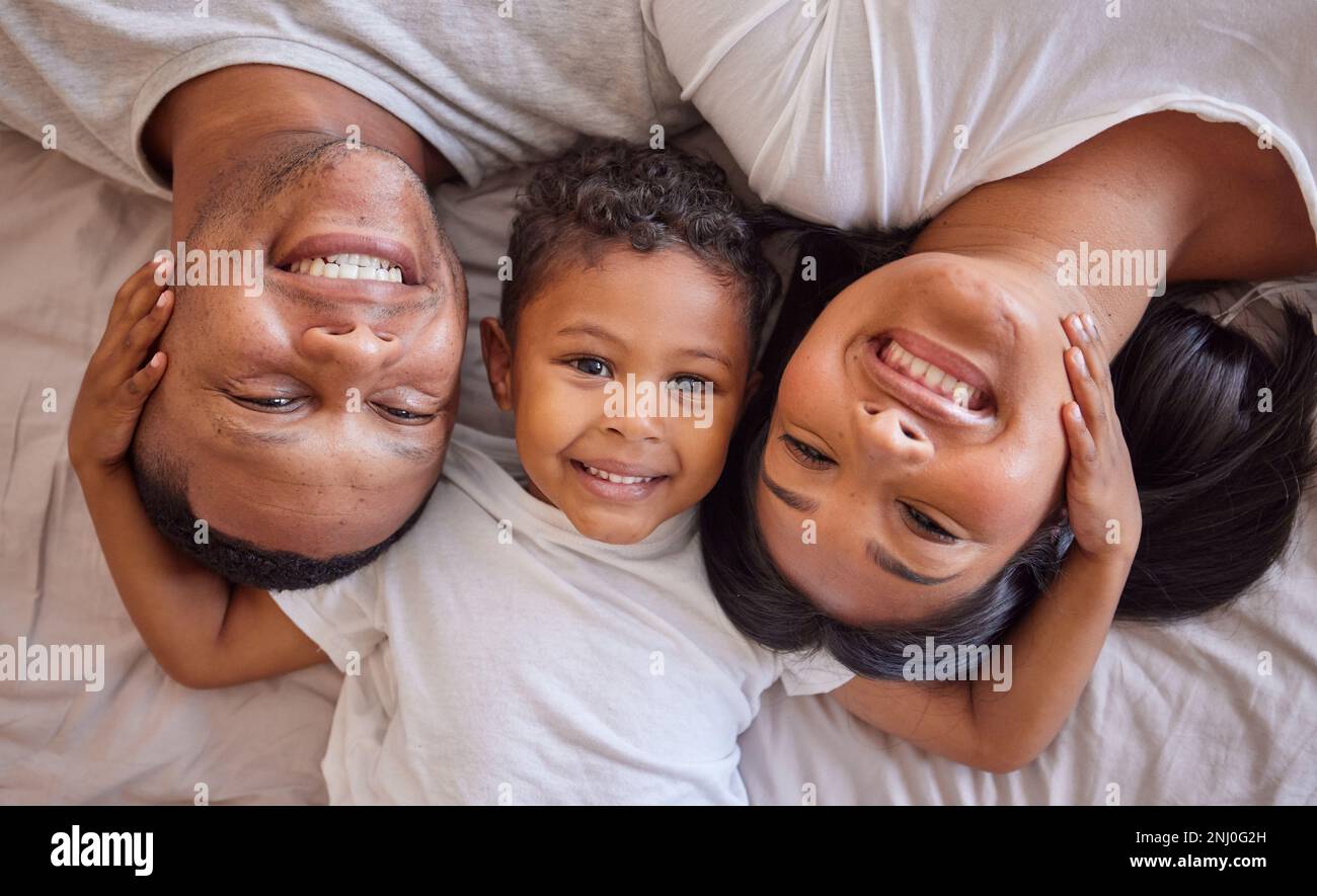 Above, portrait and happy family relax in bed, children and bonding in ...