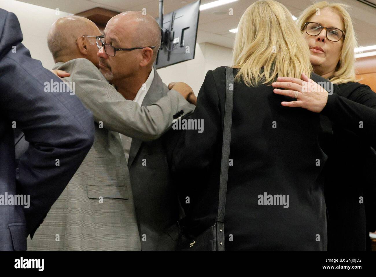 Fred and Jennifer Guttenberg, second from left, and right, embrace ...
