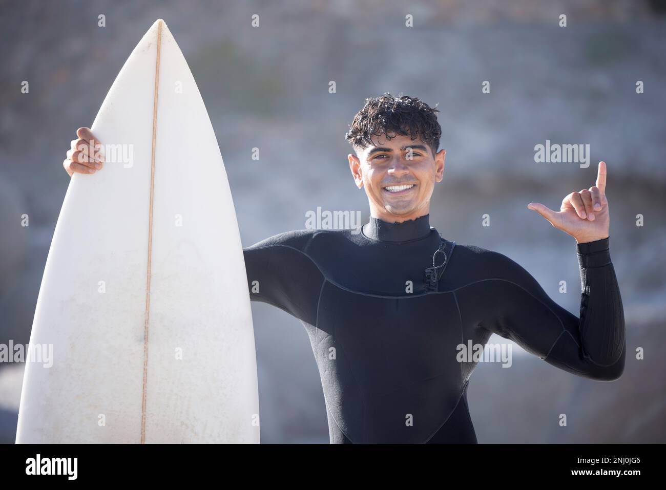 Surfer man, hand sign and portrait at beach, summer sports and freedom ...
