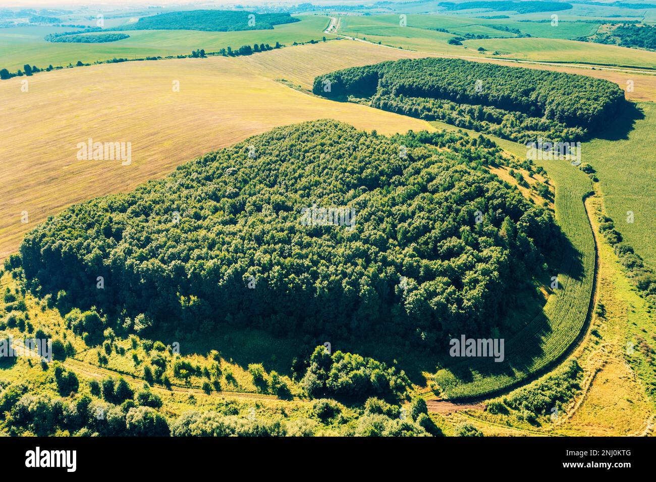 Drone view of the countryside. View of arable land and grove in a ...