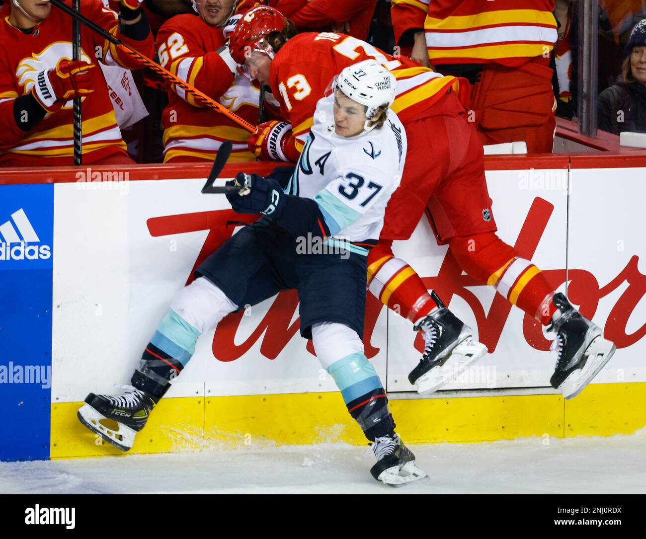 Seattle Kraken forward Yanni Gourde, right, checks Calgary Flames ...