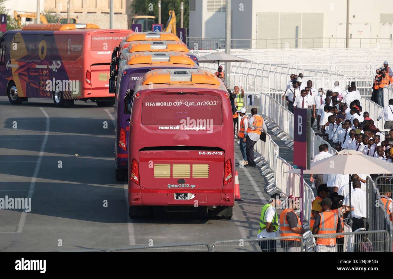 People wait in line at a temporary bus stop for FIFA World Cup Qatar in ...