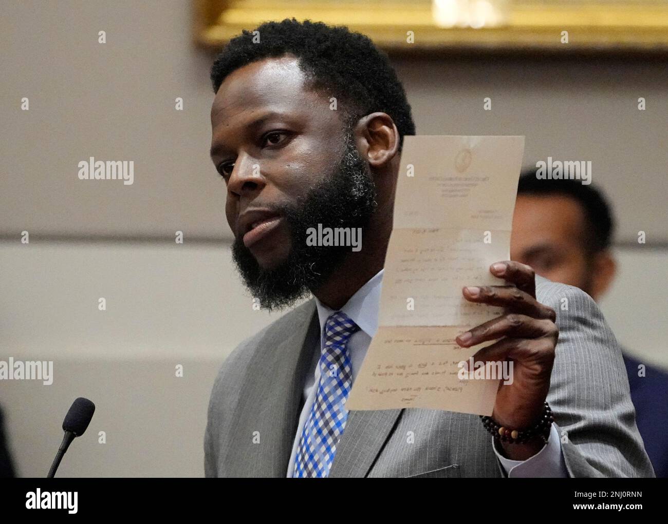 Fairfax Virginia Circuit Court Judge Dontae L. Bugg holds a note given ...