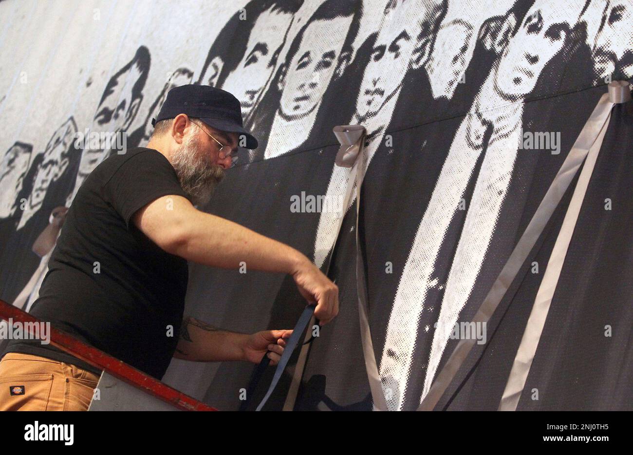 Artist Nayland Blake working on his recreated mural by Chuck Arnett ...