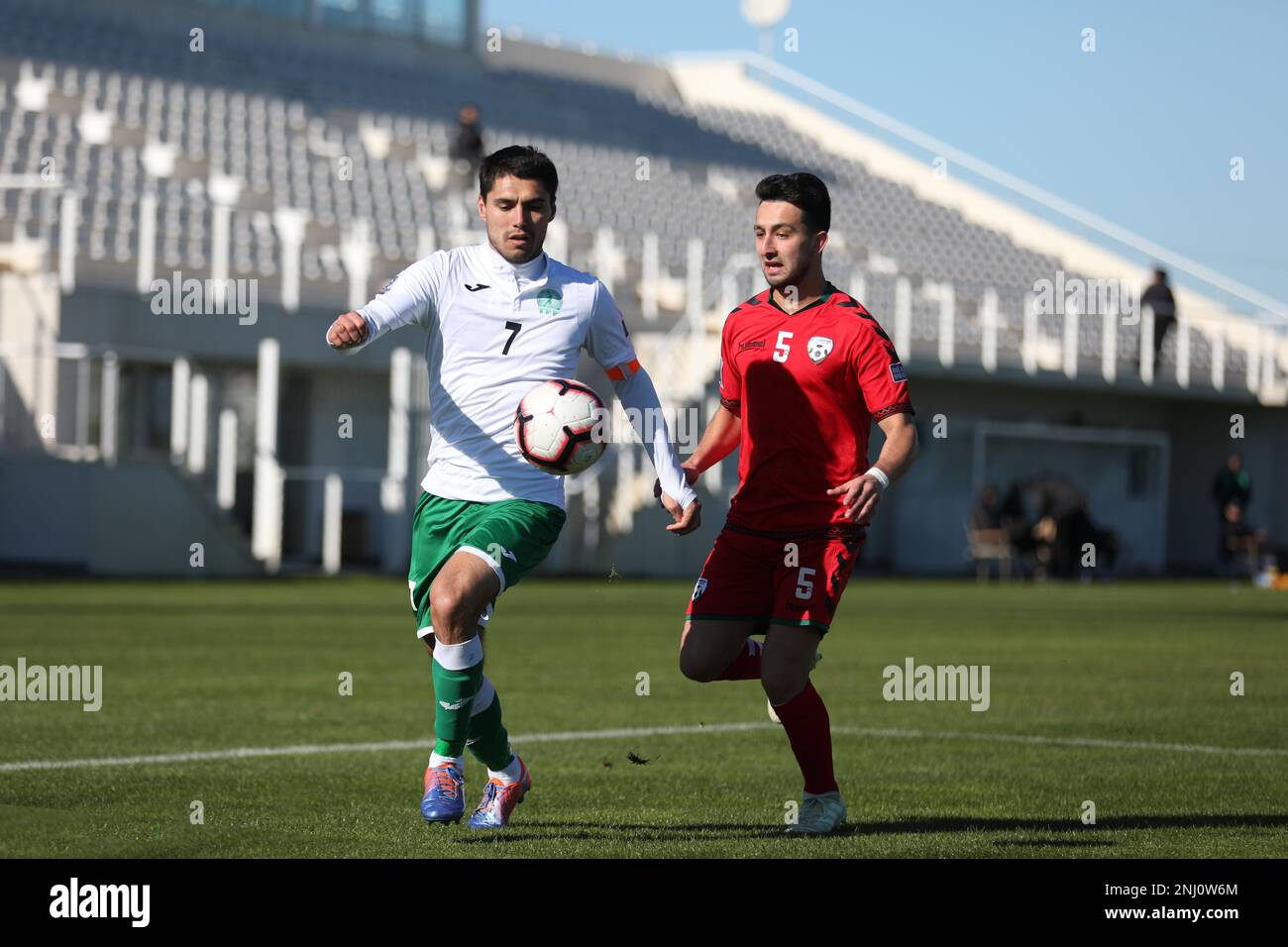 Adam Najem of Afghanistan in action with a Turkmenistan player during a ...