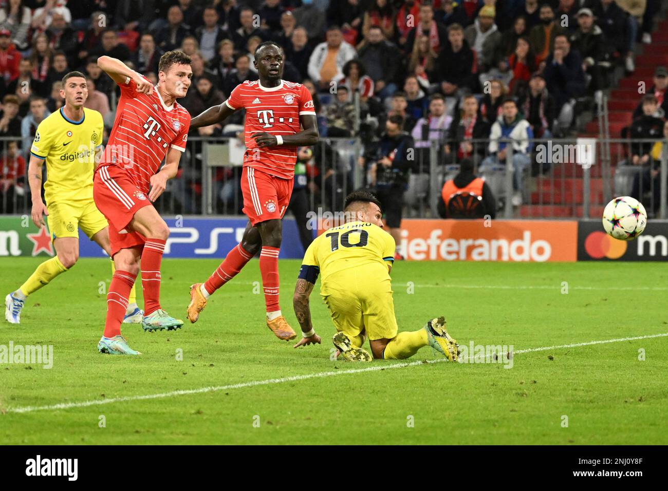 Munich's Benjamin Pavard, second left, heads in to score their side's ...