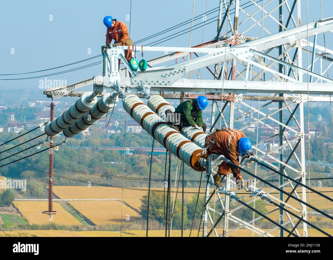 Workers perform the maintanence job on a 500kV high tension power ...