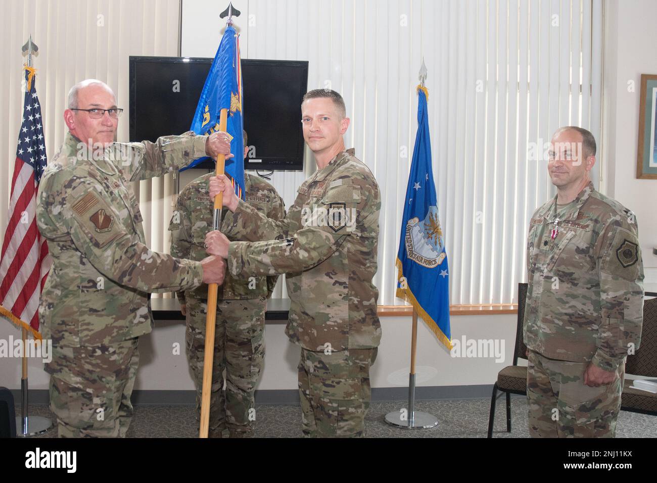 Lt. Col. Steven Eldien, receives the guidon from Col. William Miller ...