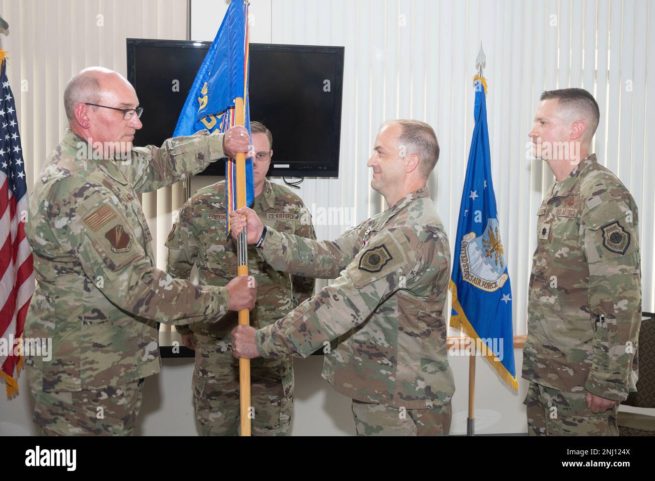 Lt. Col. Timothy Sullivan, second right, passes the guidon to Col ...