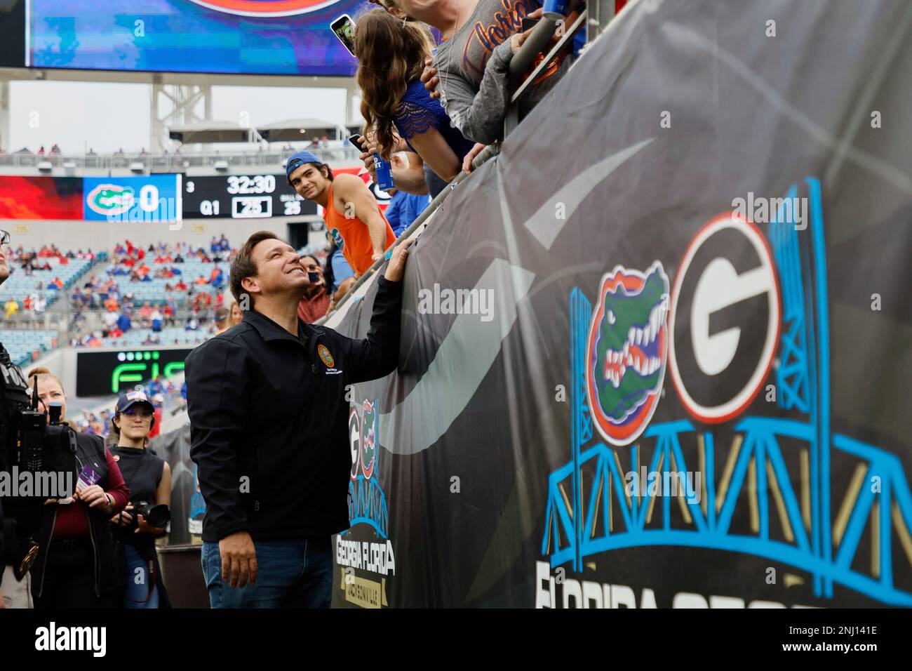 Florida's Republican Gov. Ron DeSantis interacts with fans on the ...