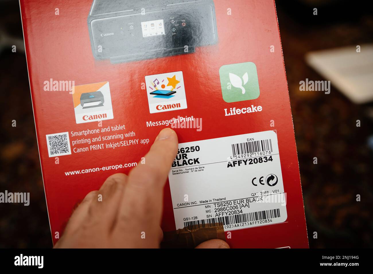 Paris, France - Feb 21, 2023: POV male hand pointing to the Canon Pixma ...