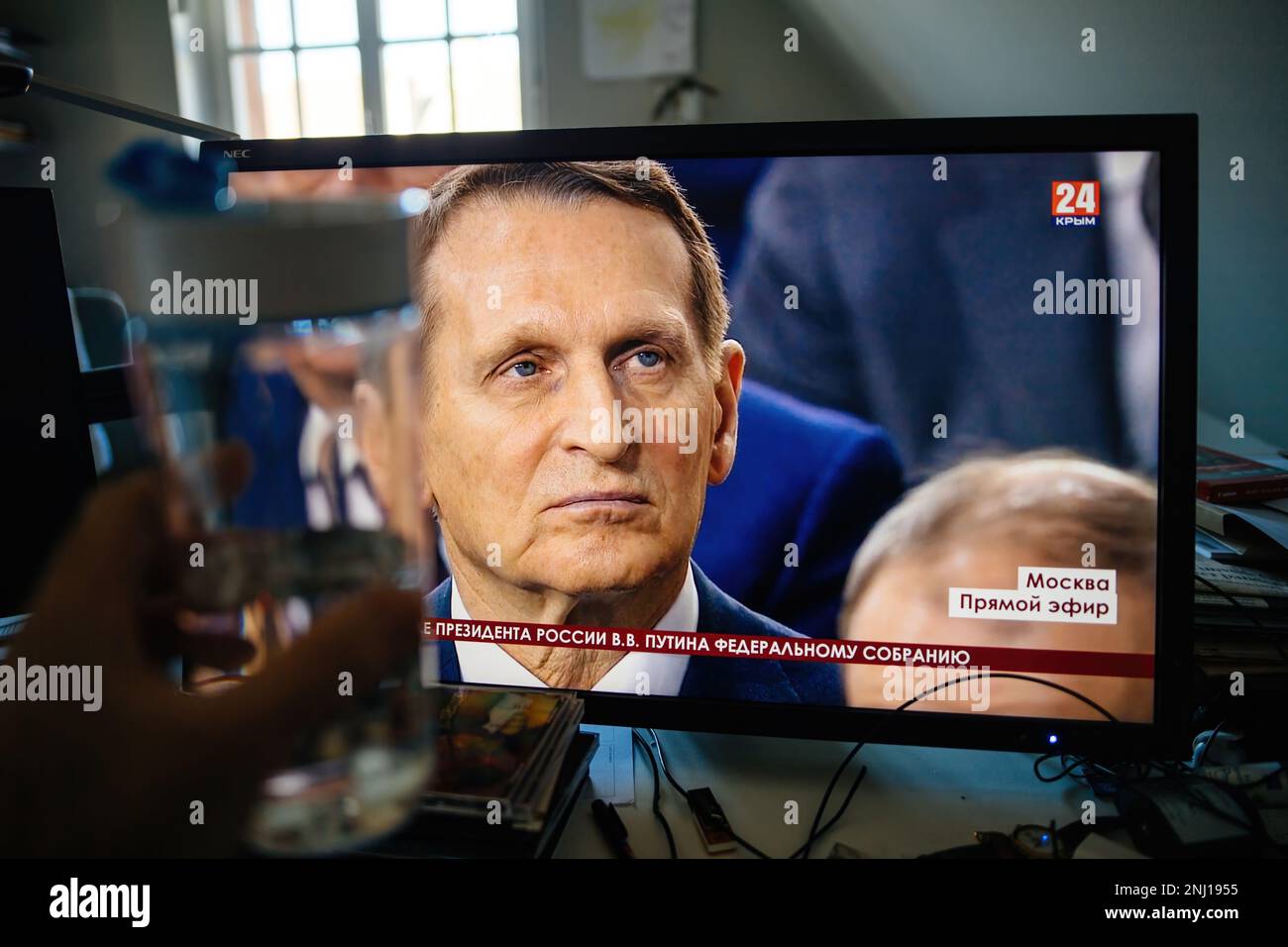 Paris, France - Feb 21, 2023: Man watching on PC Krym 24 station direct ...