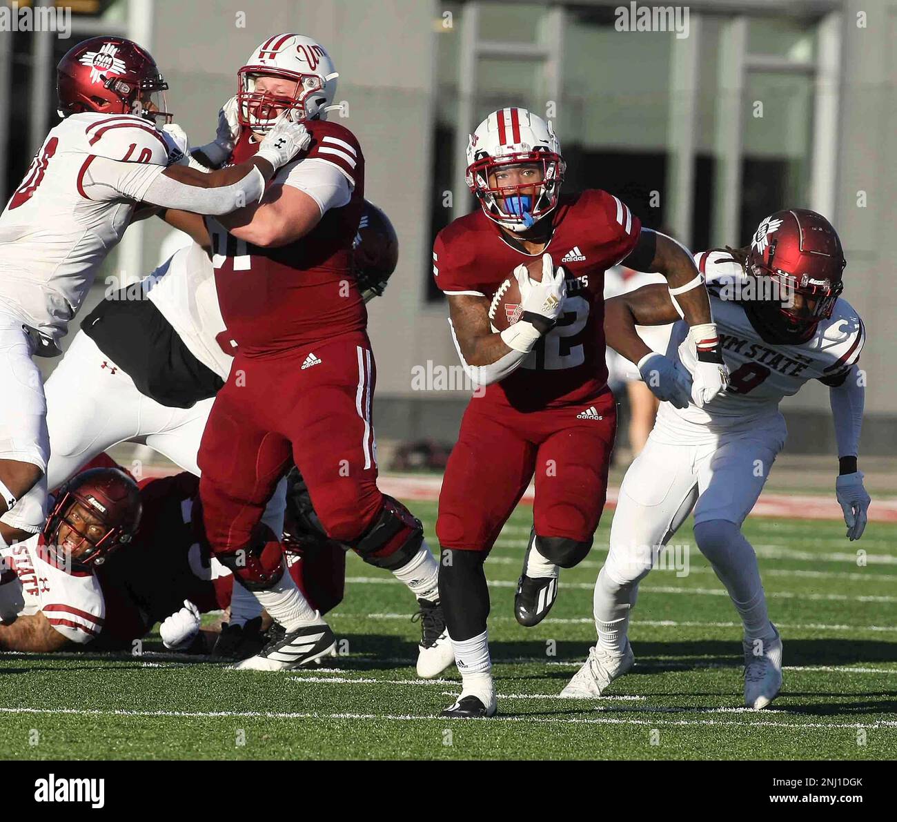 Massachusetts Kay'Ron Adams (22) powers the ball up the field past New ...