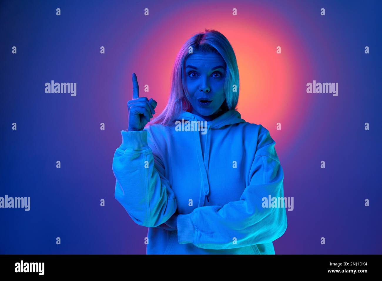 New ideas, brainstorming. Young beautiful woman rising finger, posing ...