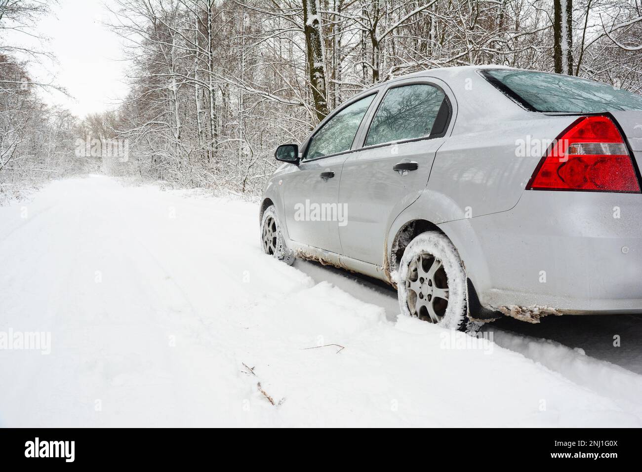 Driving a sedan car in deep snow. Driving a gray sedan car through a ...
