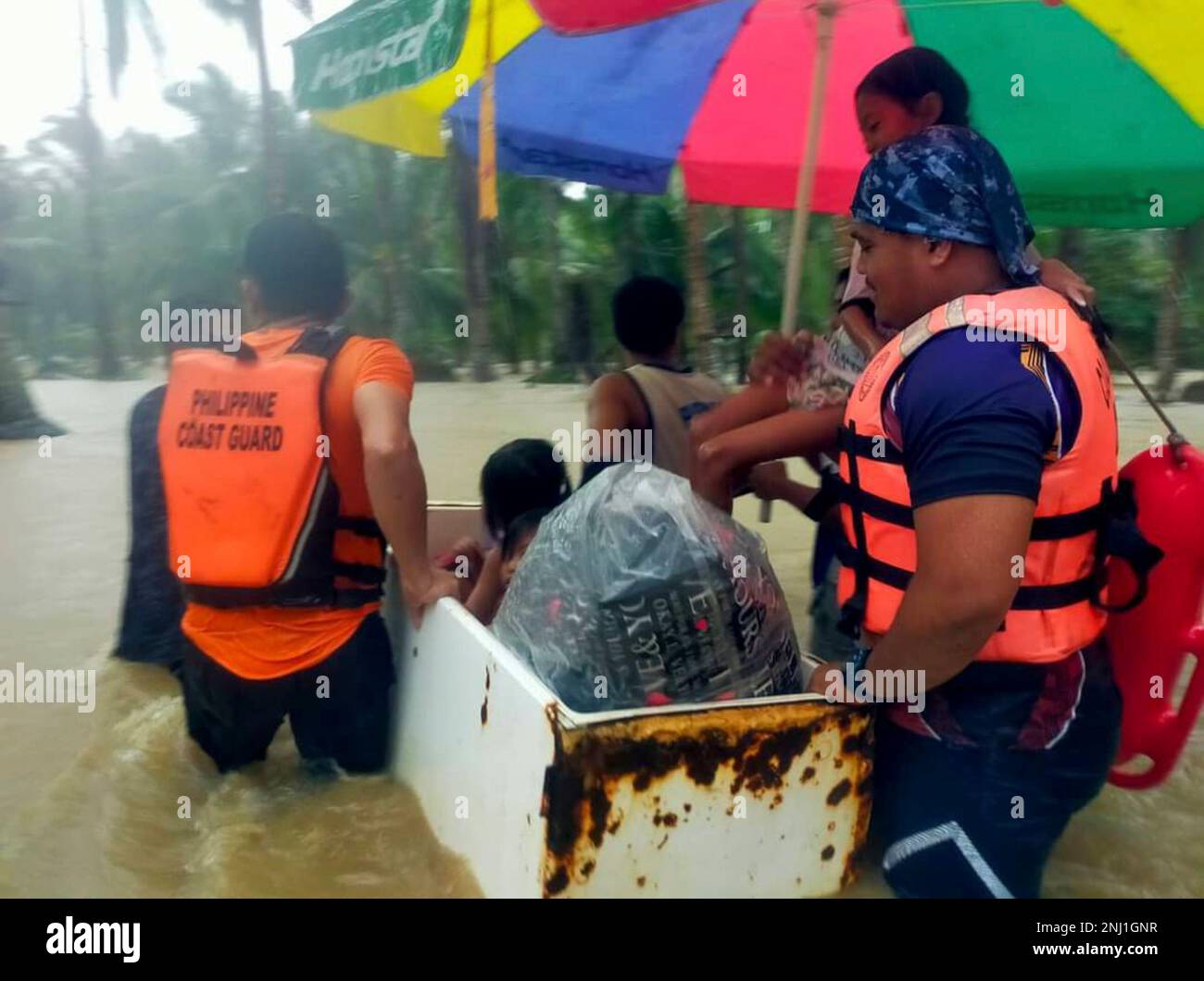 In this photo provided by the Philippine Coast Guard, rescuers use an ...