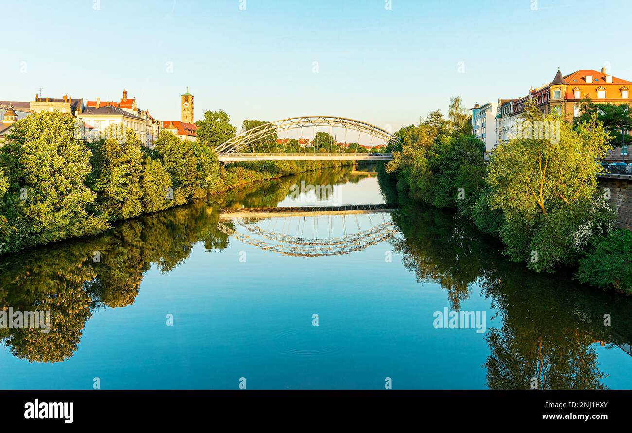 Luitpold Bridge mirroring in Regnitz River with Church of the Redeemer ...