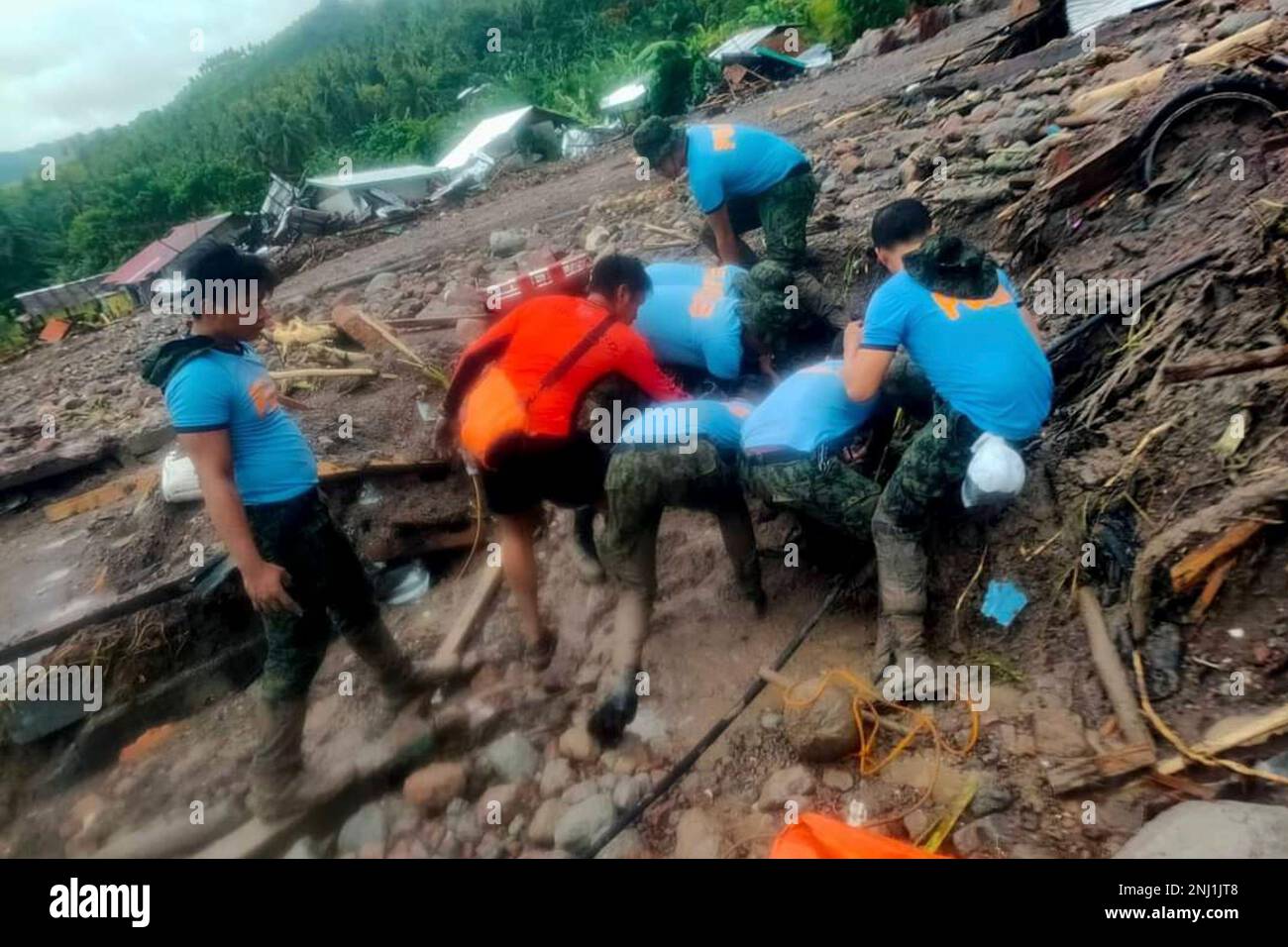 In this handout photo provided by the Philippine Coast Guard, rescuers retrieve bodies during ...